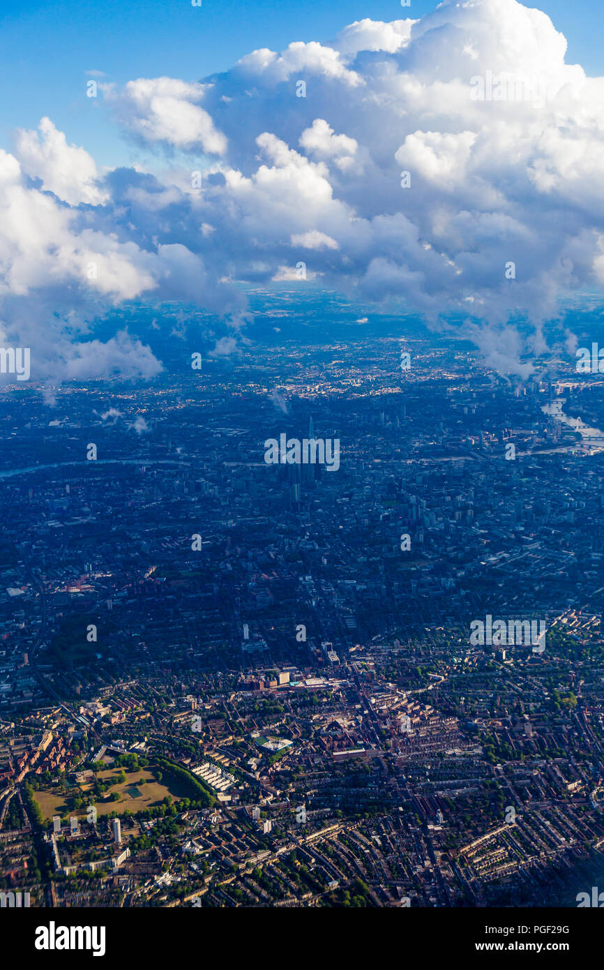 aerial view of the city of London from airplane window seat approaching ...