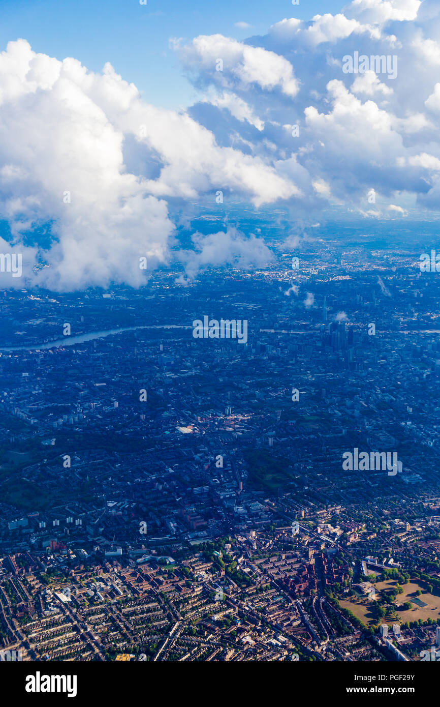 aerial view of the city of London from airplane window seat approaching ...