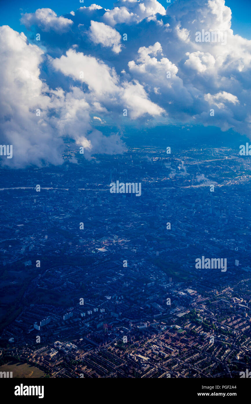 aerial view of the city of London from airplane window seat approaching ...