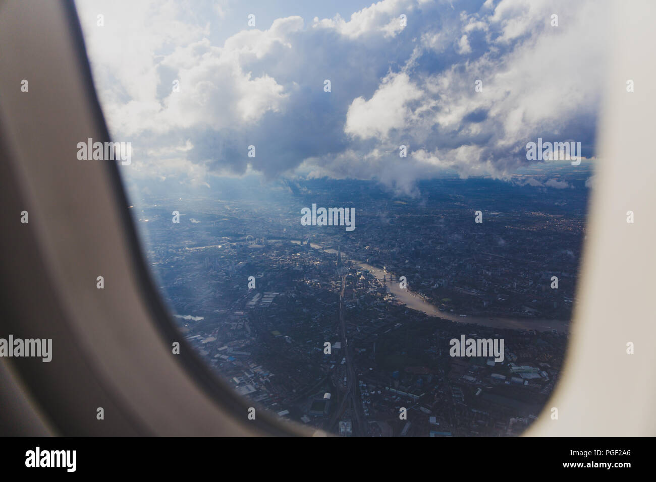 aerial view of the city of London from airplane window seat approaching ...
