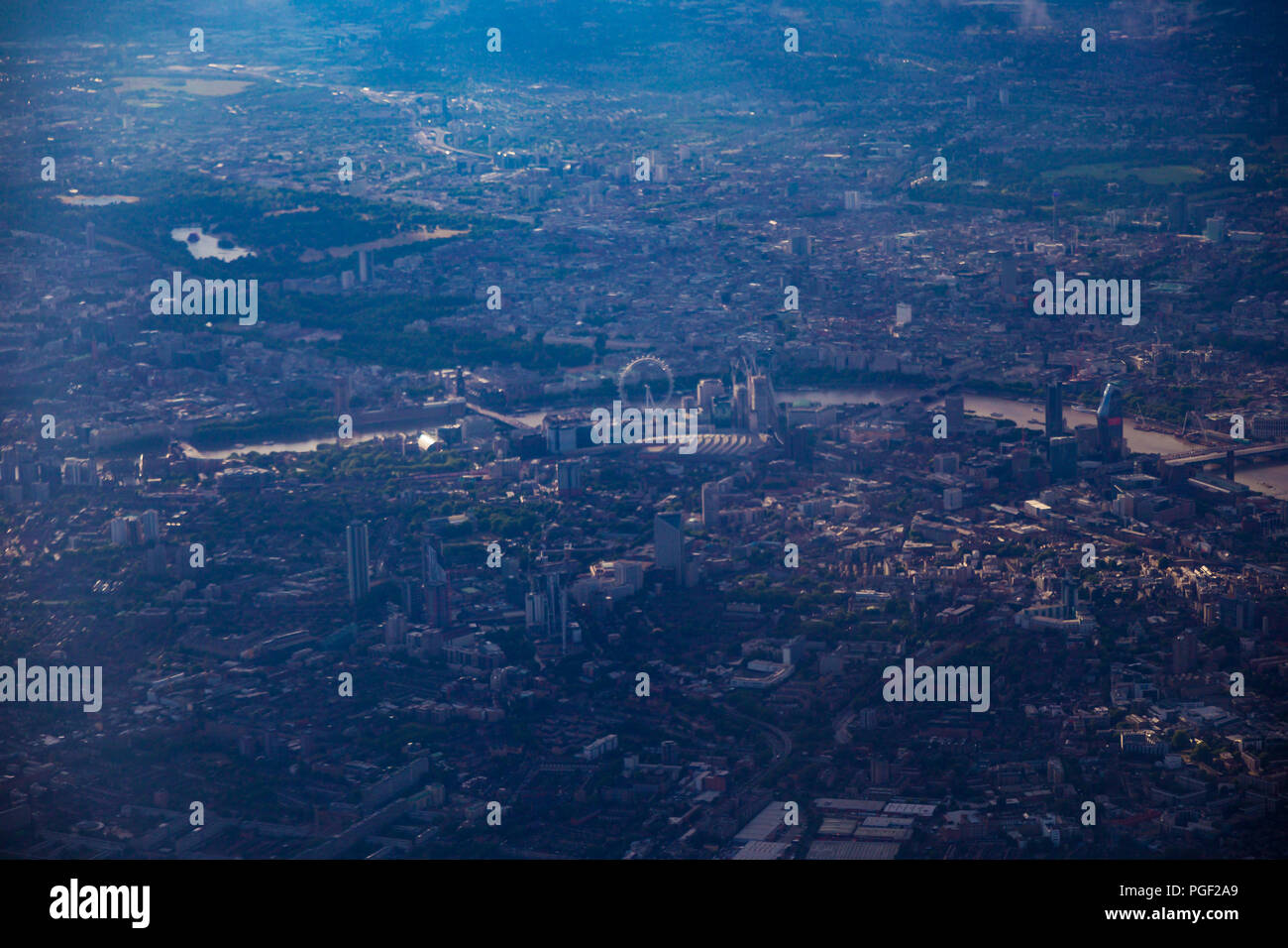 aerial view of the city of London from airplane window seat approaching ...