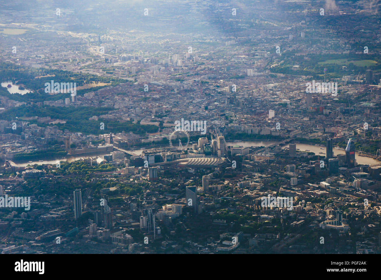 aerial view of the city of London from airplane window seat approaching ...