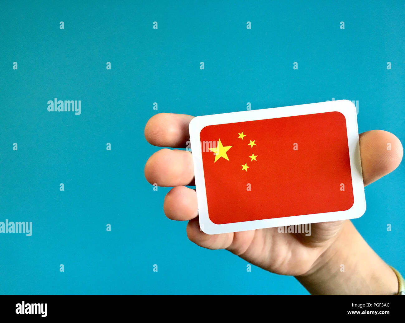 Human hand holding national flag of China Stock Photo - Alamy