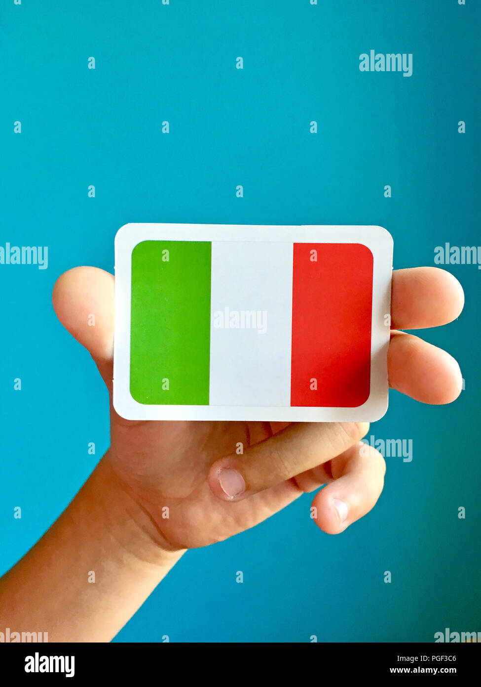 Card with a national flag of Italy in human hand Stock Photo - Alamy