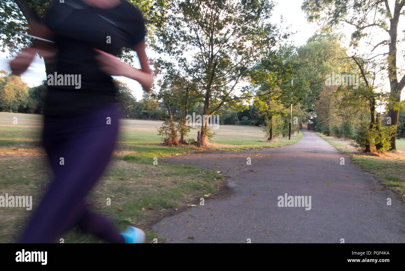 A female runner runs past at speed Stock Photo - Alamy