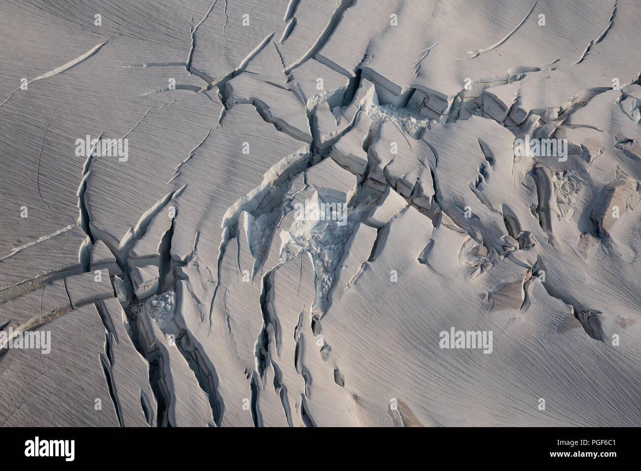 Aerial view of the rugged and dangerous terrain on a glacier mountain ...