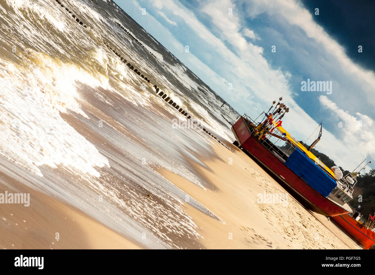 Fishing boat on the sandy beach in Rewal - Poland Stock Photo - Alamy