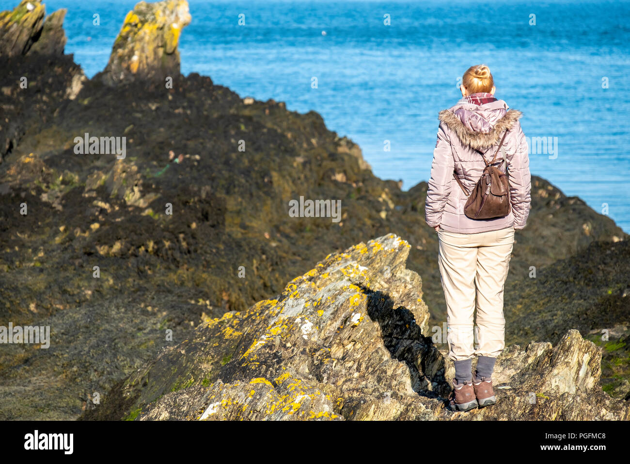 Lady observing the sea at Bull Bay on Anglesey, Wales - UK Stock Photo ...