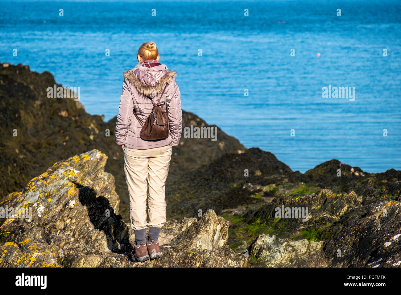 Lady observing the sea at Bull Bay on Anglesey, Wales - UK Stock Photo ...