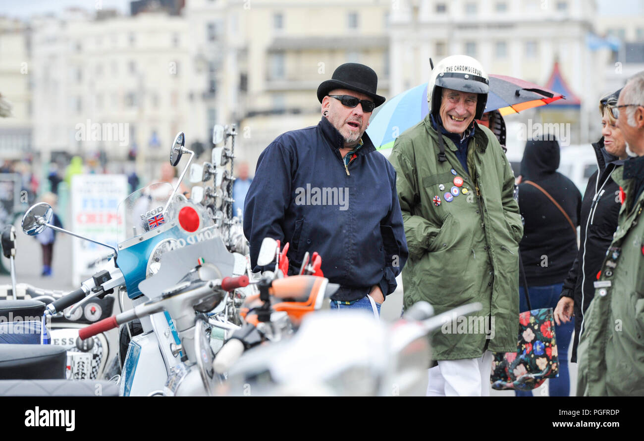 Brighton, UK. 26 August 2018. Despite the bad weather Mods with their ...
