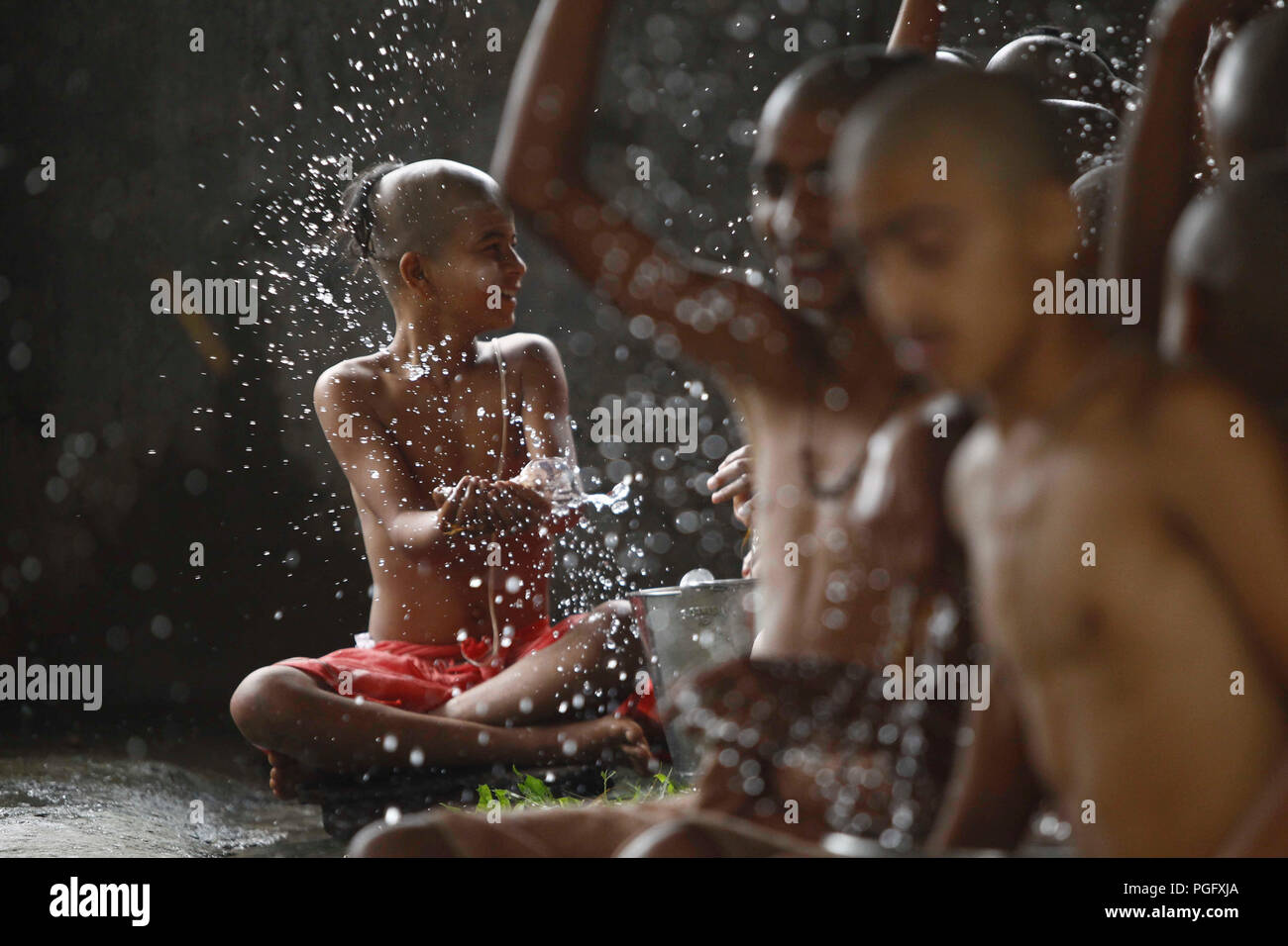 Beijing, China. 26th Aug, 2018. Young Hindu priests take bath during ...