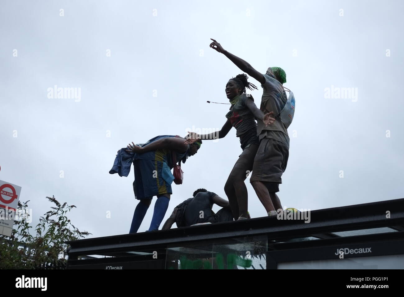 London, UK. 26th Aug, 2018. Dancing on top of bus stop despite much ...