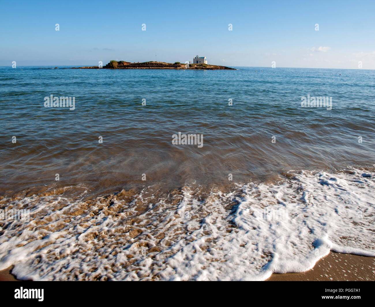 Picturesque small Chapel on island across Malia beach, Crete. Greece ...