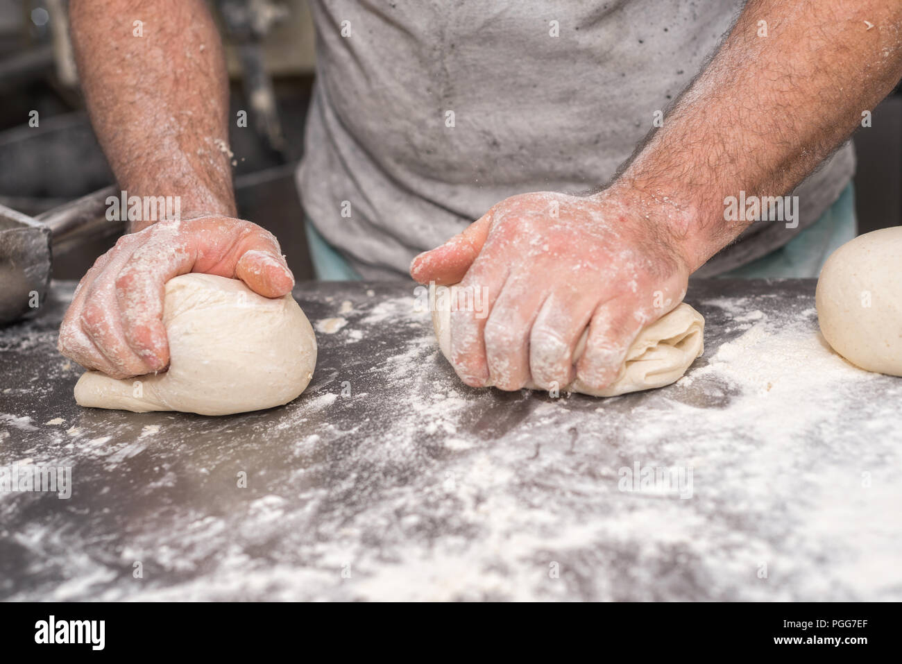 Baker hands kneading bread dough Stock Photo - Alamy
