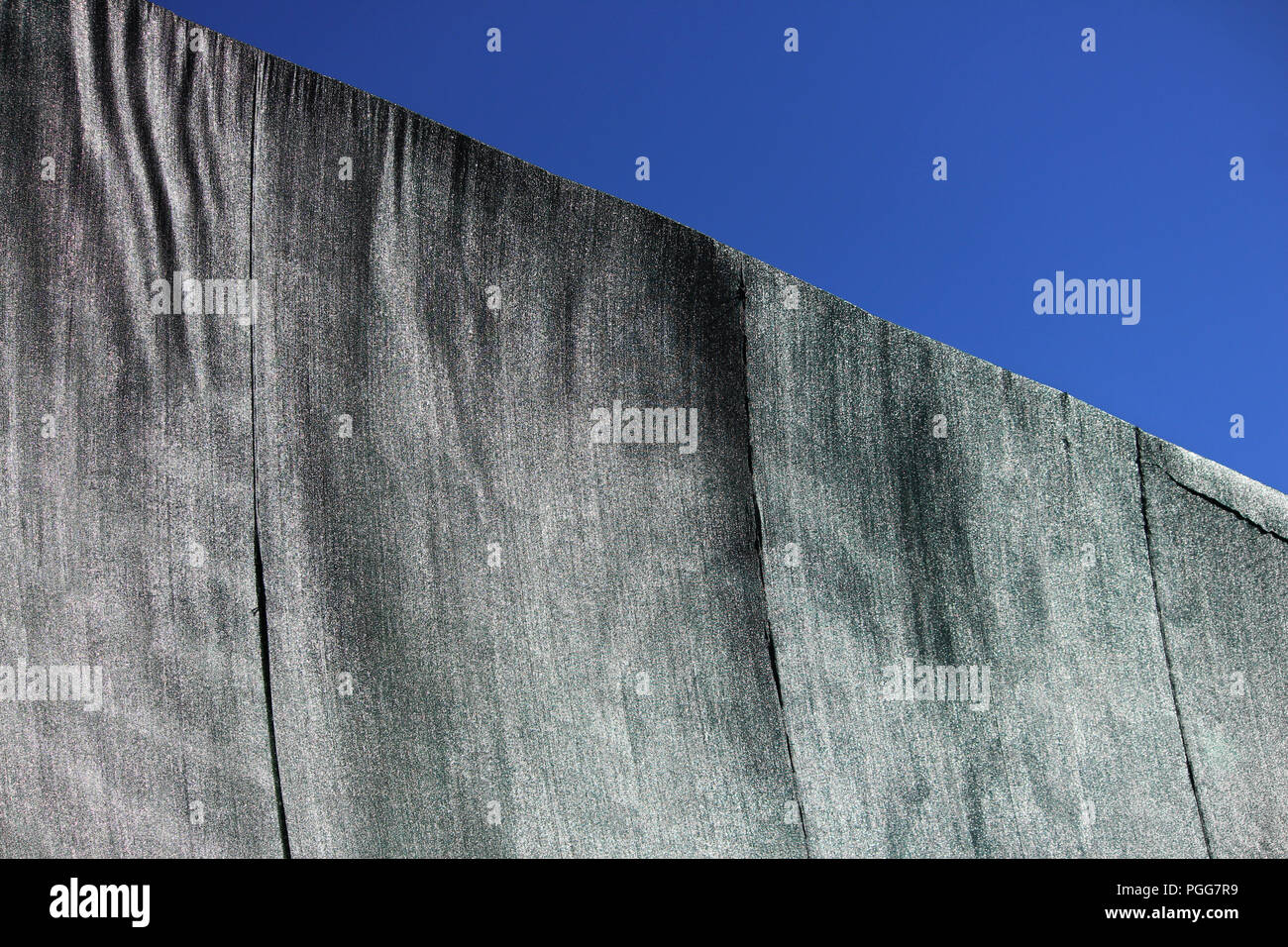 The green building mesh protects the old historical building from ...