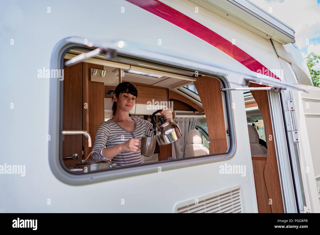 Woman cooking in camper, motorhome interior VR. Family vacation travel ...