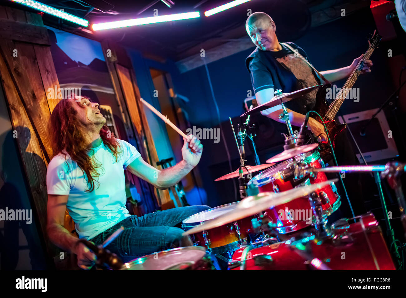 Drummer playing on drum set on stage. Authentic shooting with high iso ...
