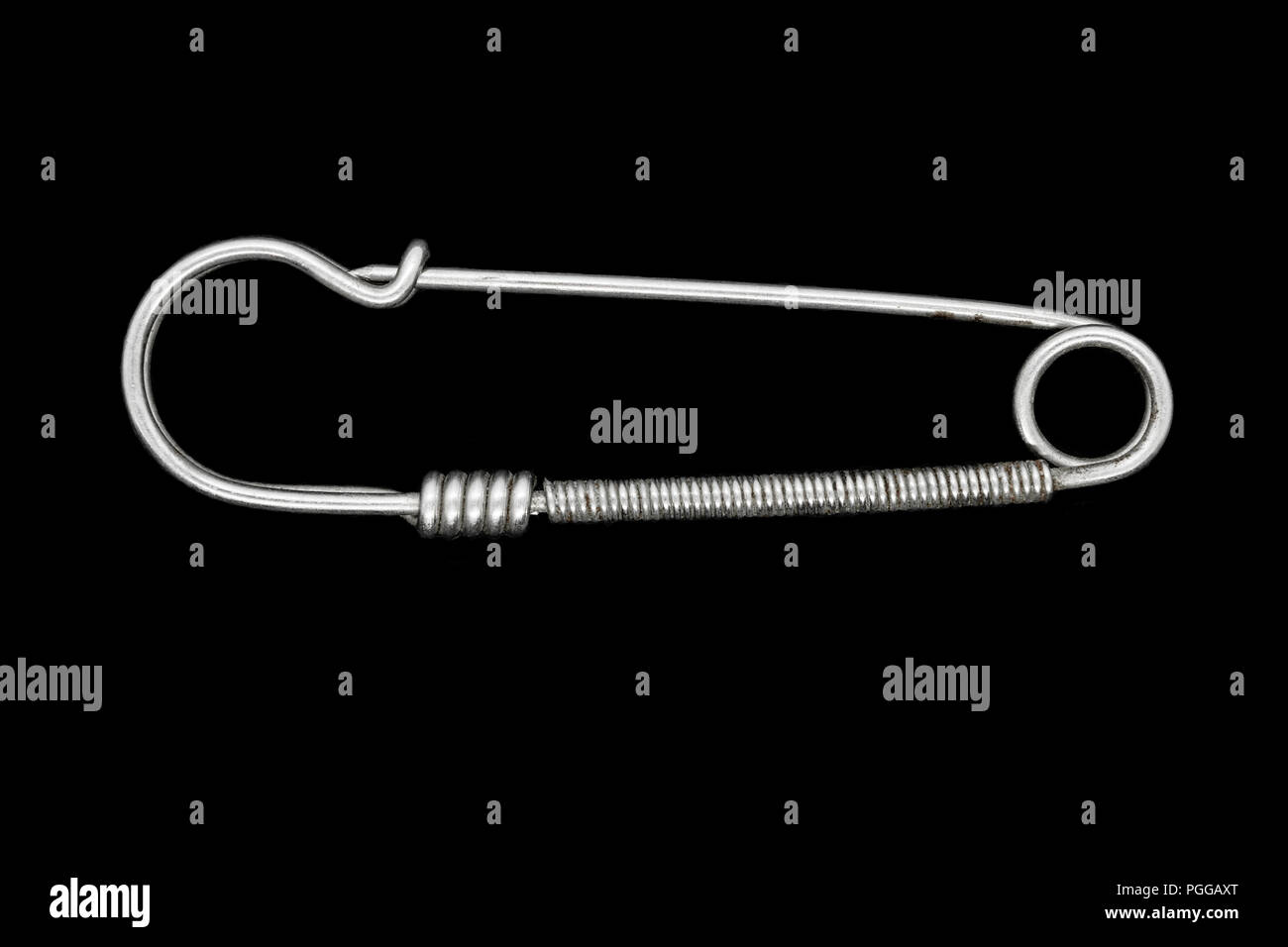 Very old, rusty and vintage metal safety pin isolated on black ...