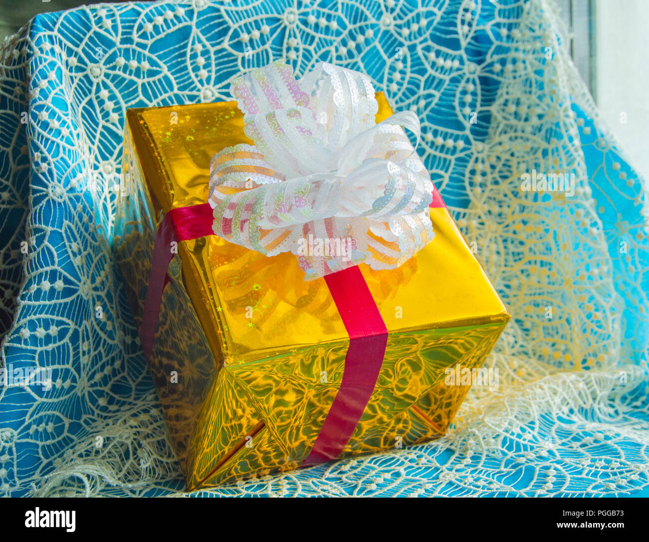 Gift in a Golden package and snowflake beautiful blue background Stock ...