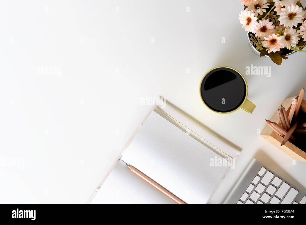Top view office desk with notebook paper, pencil, computer keyboard and ...