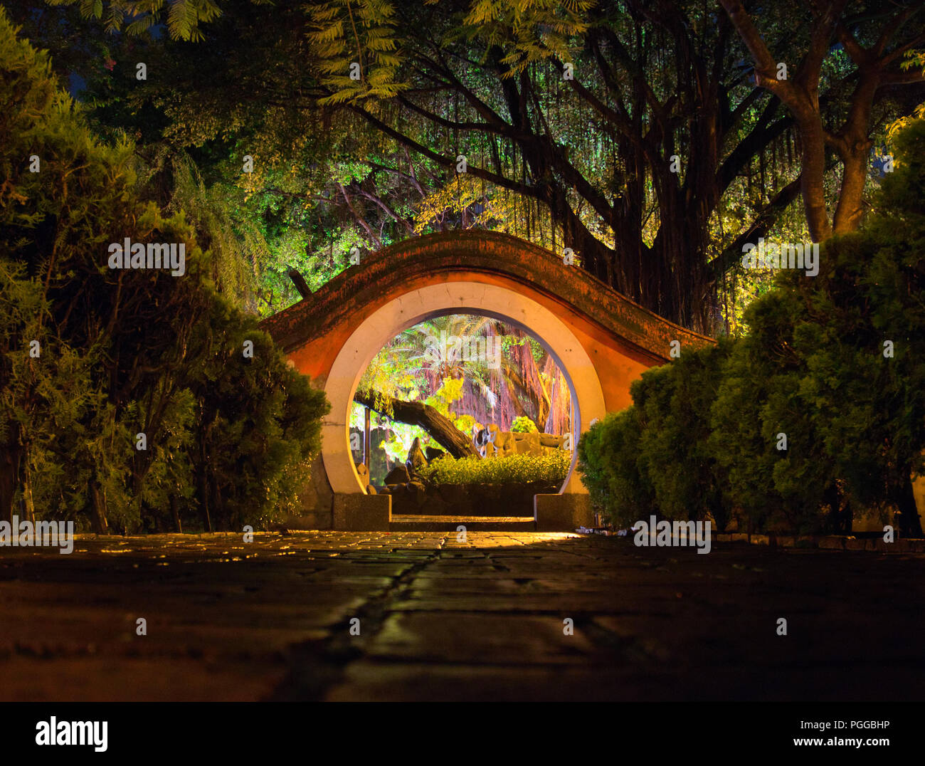 Round entrance gate at the end of a stone paved street viewed from ...