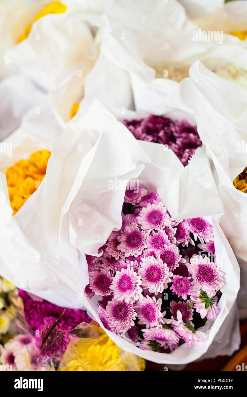 Fresh bunch of flowers in paper bag at outdoor market Stock Photo - Alamy