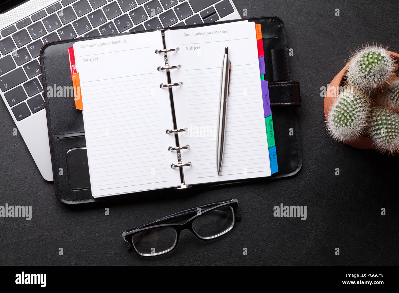 Office workplace table with notepad and laptop. Flat lay. Top view with ...