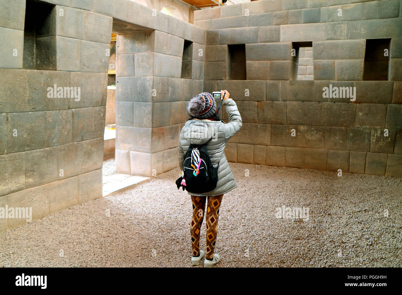 Female tourist taking pictures inside Coricancha, the Temple of the Sun ...