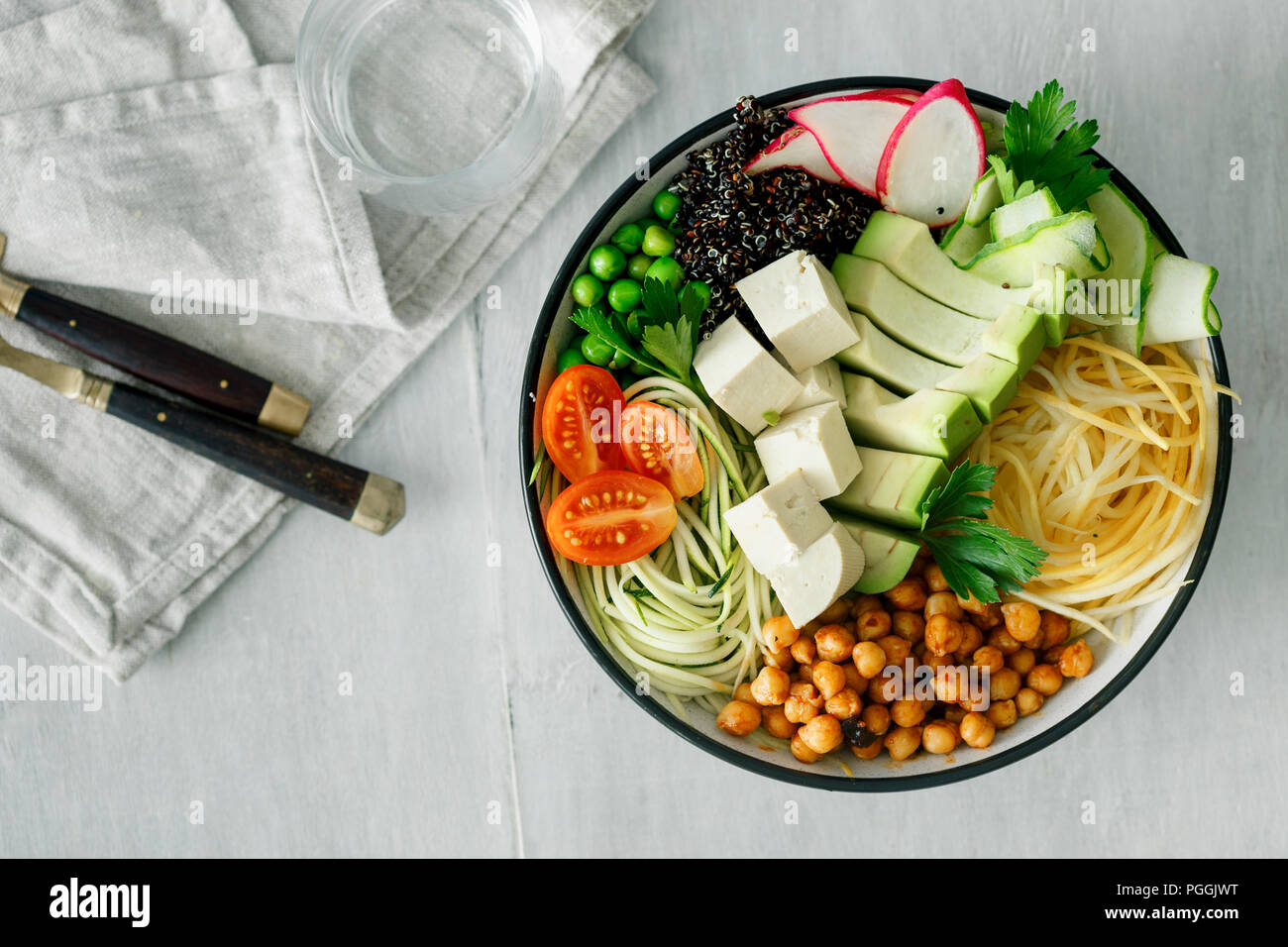 Close up bowl of buddha with spiralized vegetables on white wooden ...
