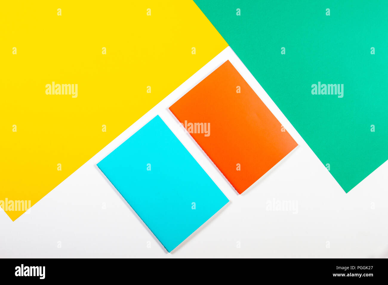 Colorful notebooks on green yellow white background Stock Photo - Alamy