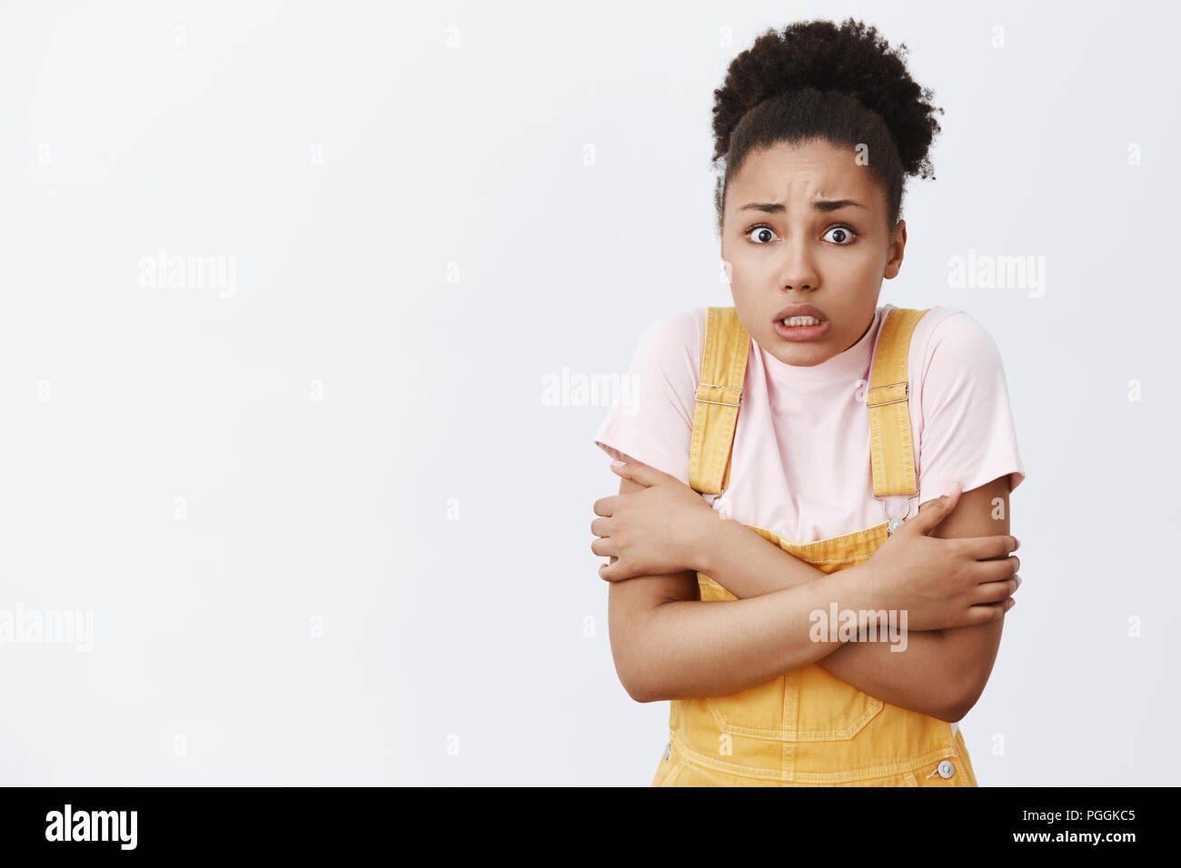 It is freezing like in fridge. Trembling cute African American girl in ...