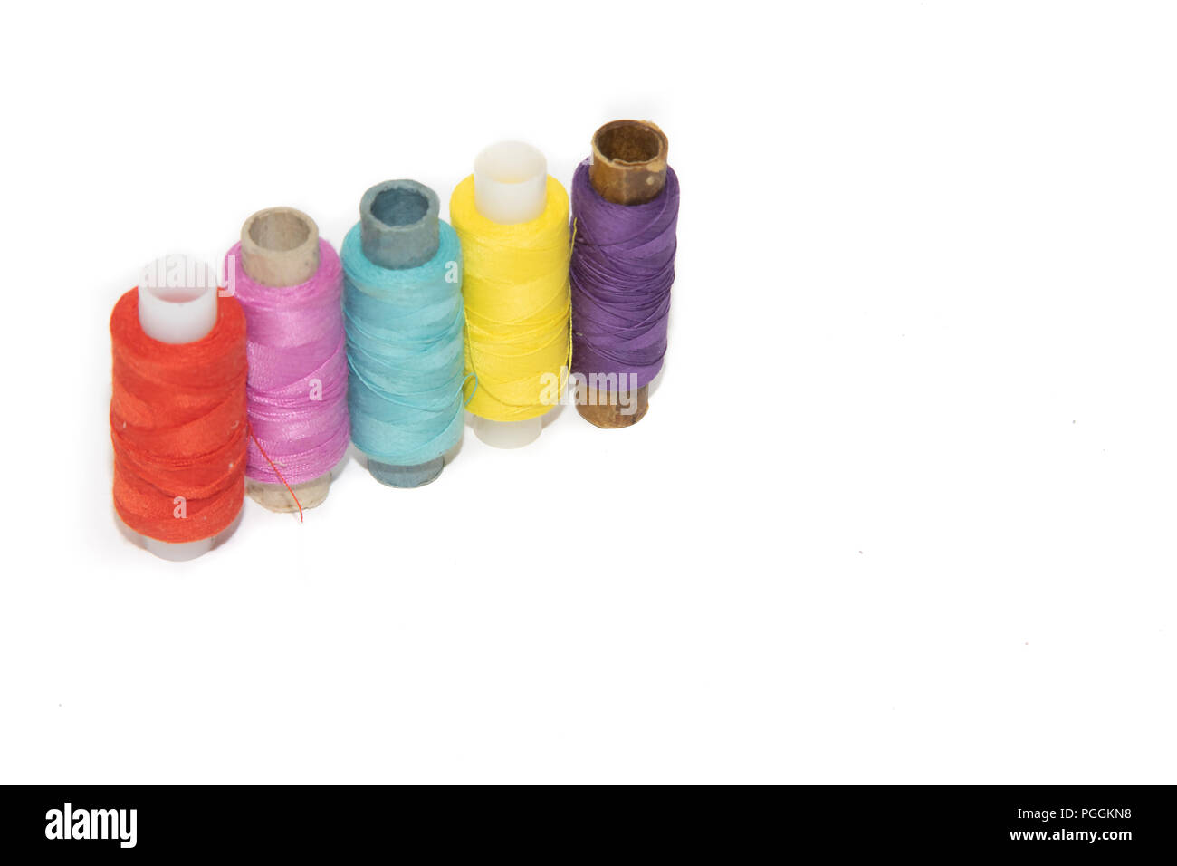 colored thread on white background. items for embroidery. handmade ...