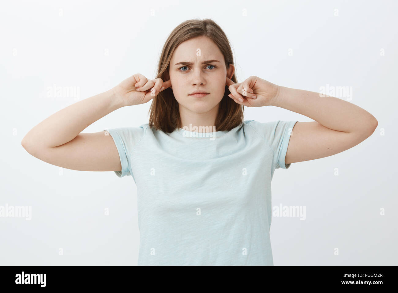 Girl not going listen shutting up ears. Intense serious-looking ...