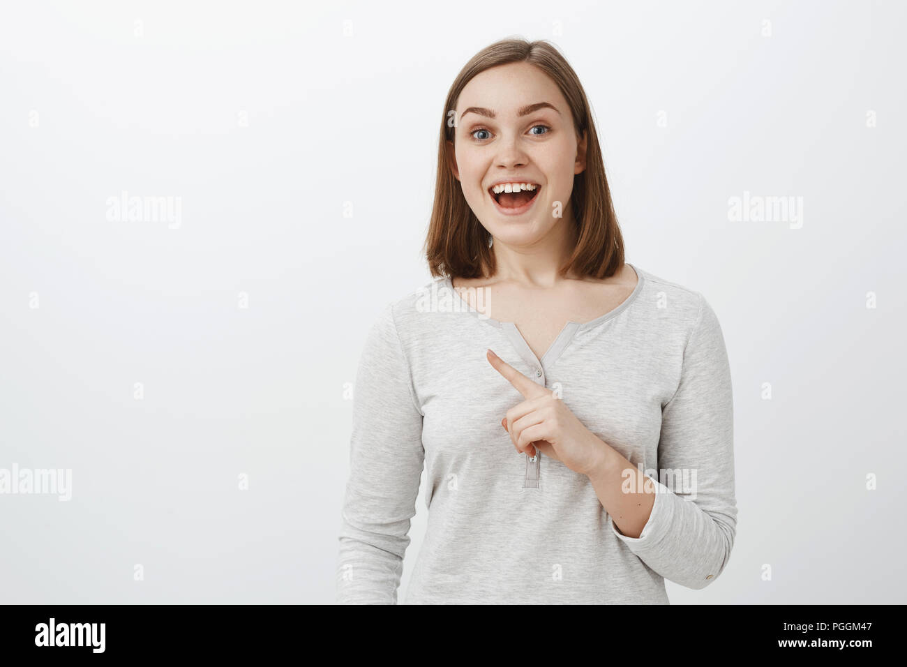 Waist-up shot of enthusiastic energized cute girl reacting to awesome ...