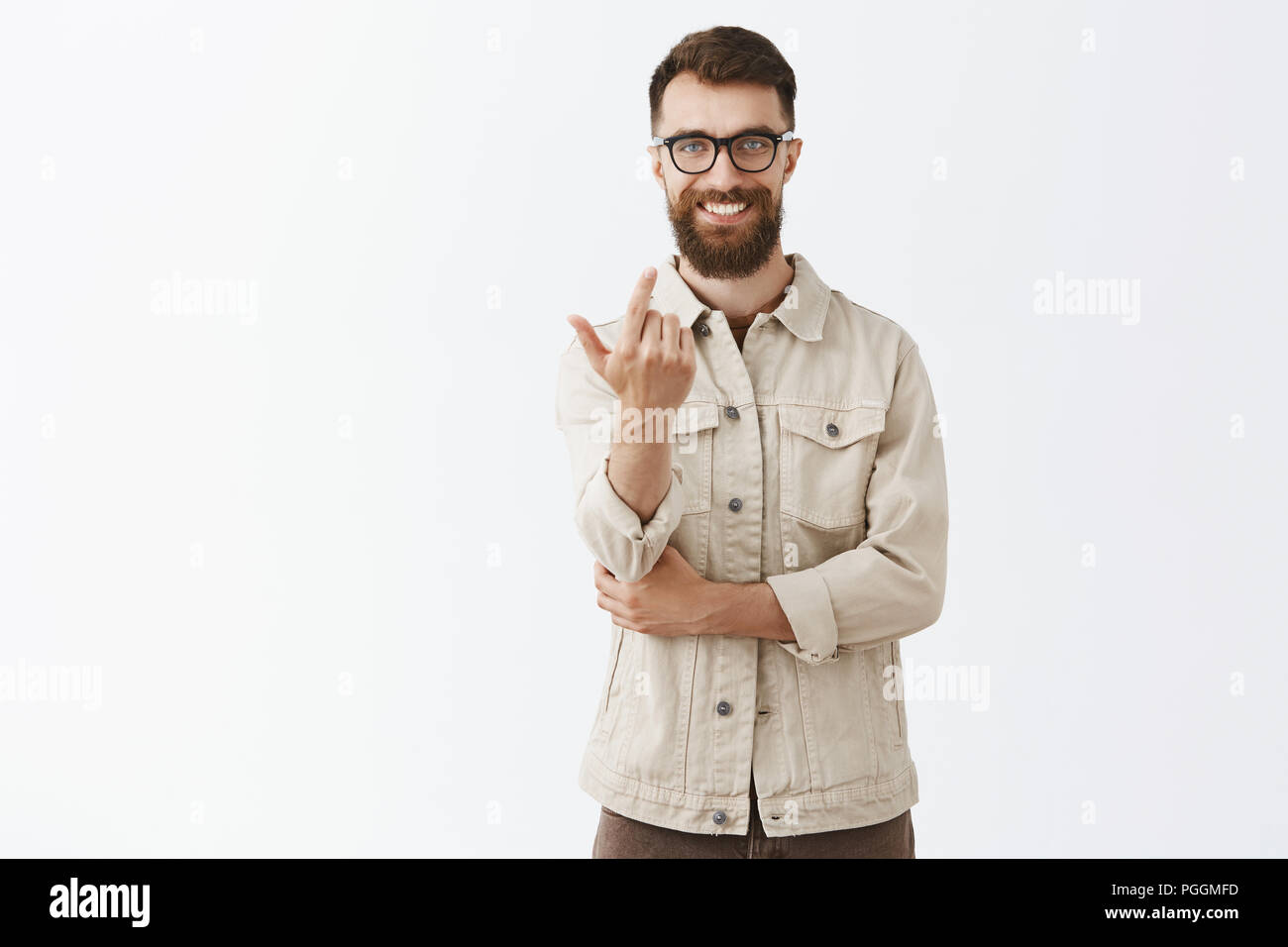 Cheerful businessman pointing finger inviting hi-res stock photography ...