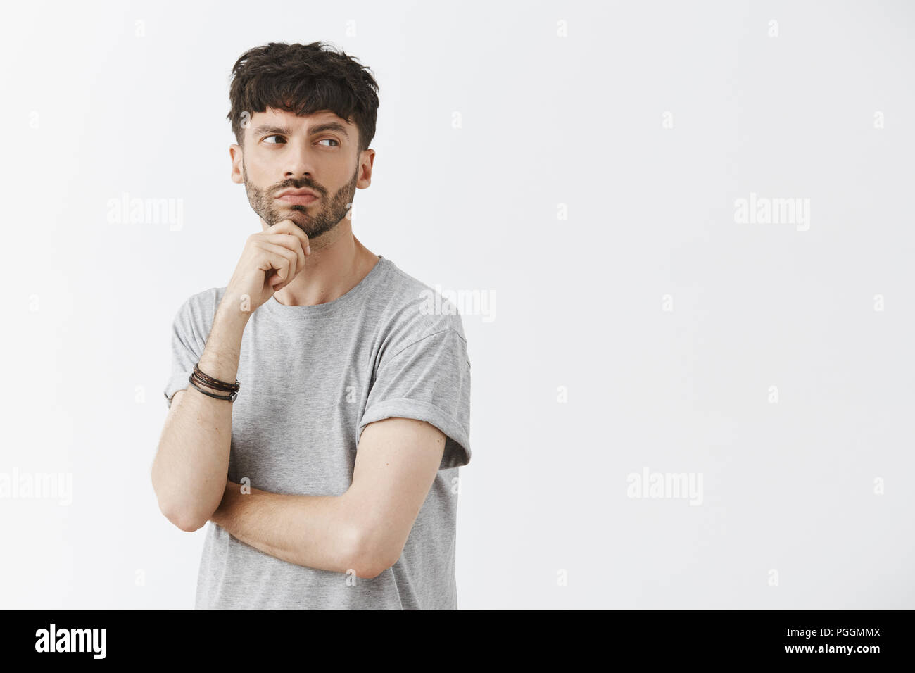 Waist Up Shot Of Creative Thoughtful Intrigued Good Looking Guy With