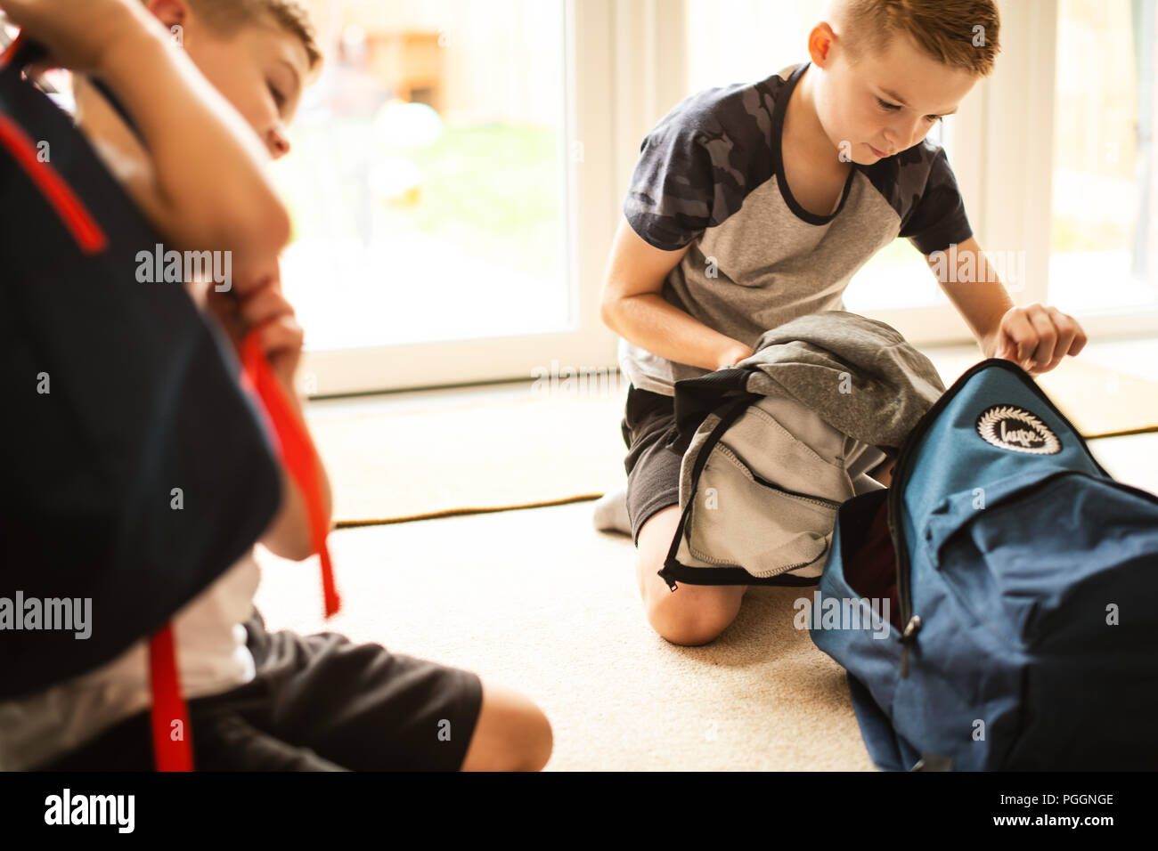 Boys packing rucsacs for expedition Stock Photo - Alamy