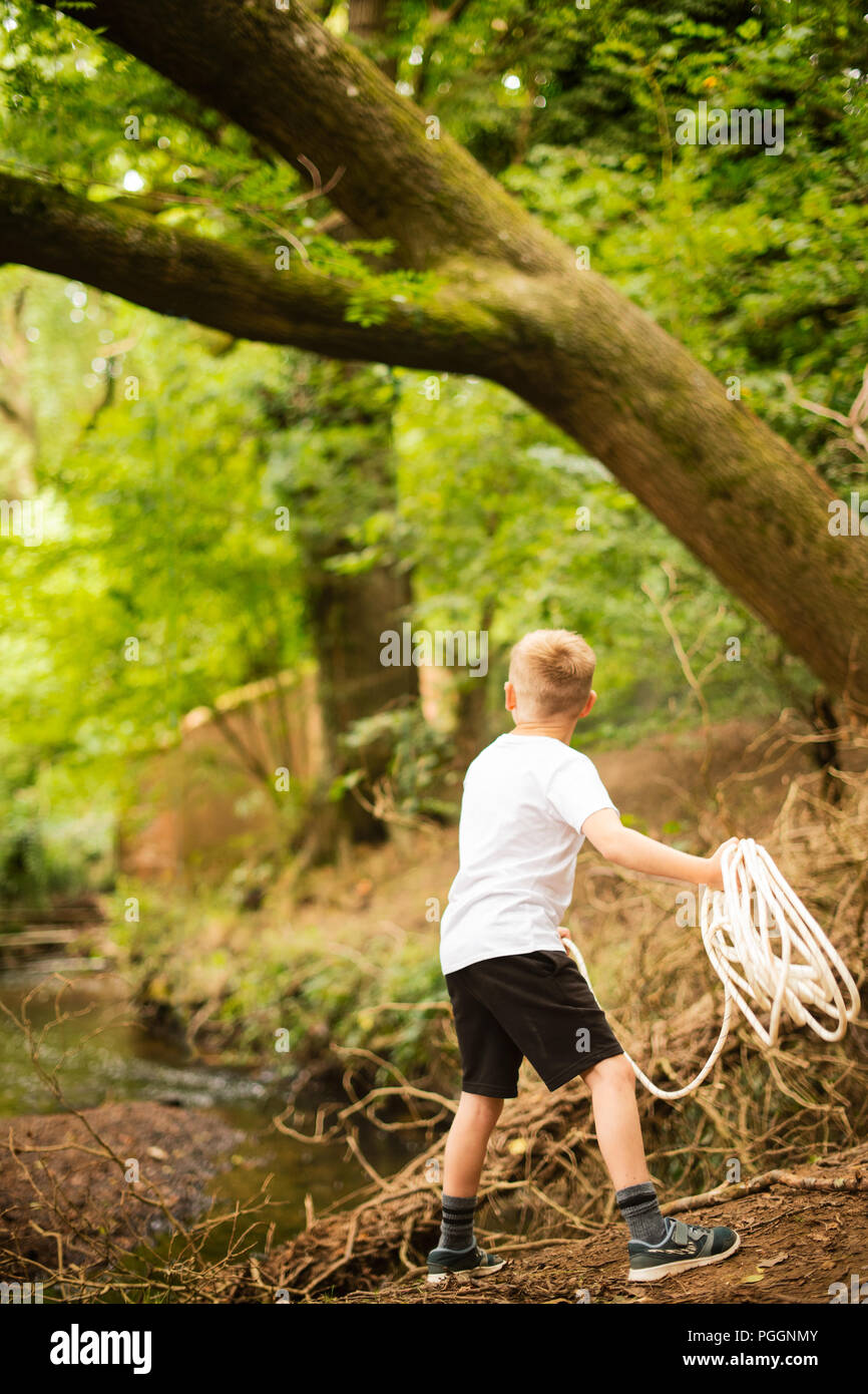 Boy throwing coiled rope Stock Photo - Alamy