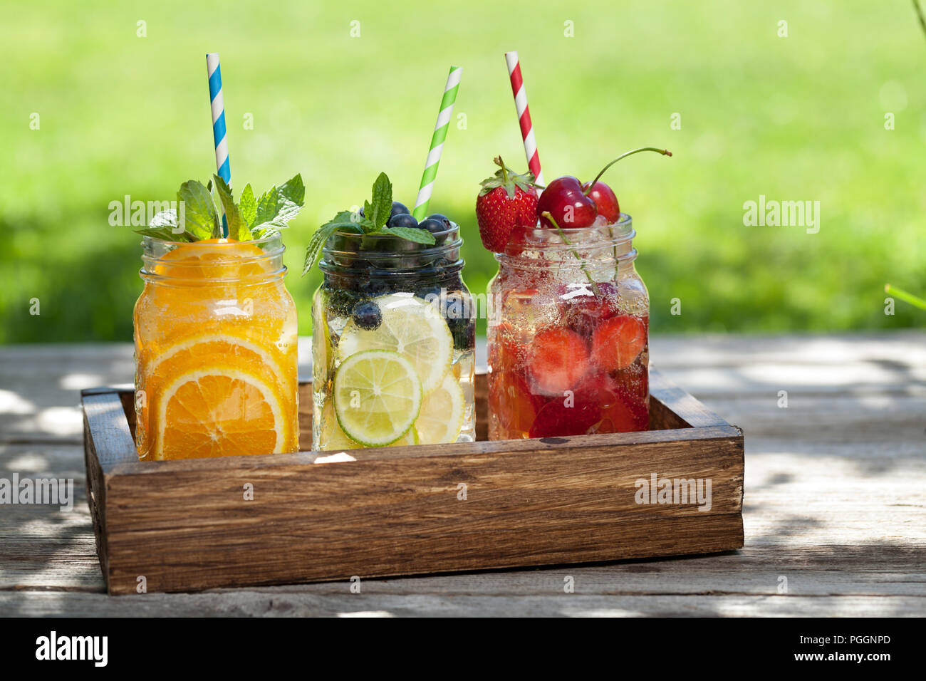 Fresh lemonade jar with summer fruits and berries. With space for your ...