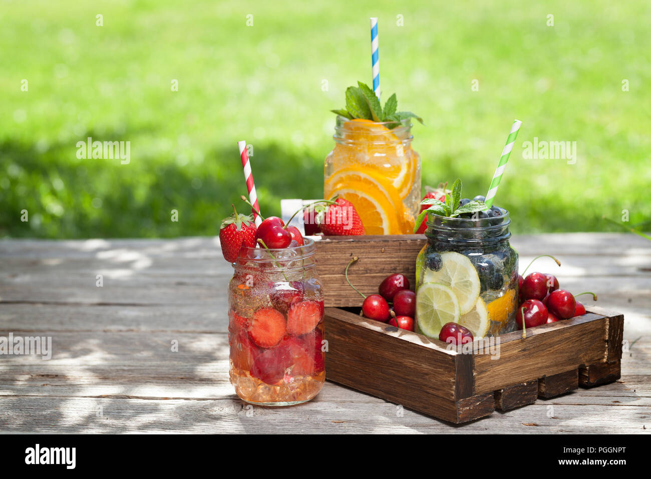 Fresh lemonade jar with summer fruits and berries. With space for your ...