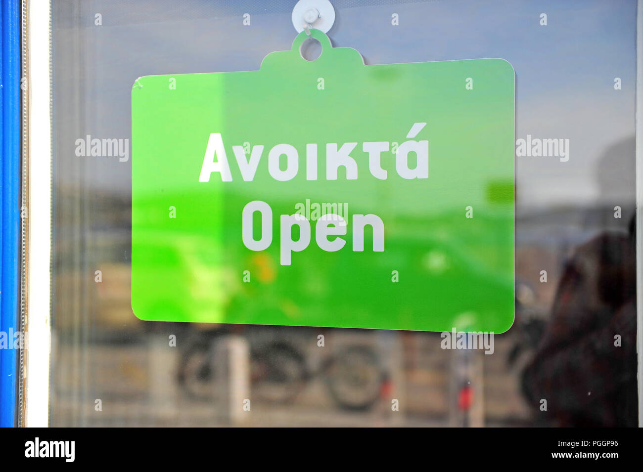 Colorful open sign in greek and english languages in glass Stock Photo ...