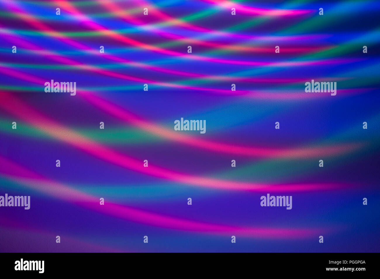 Disco lights with multicolored light streaks of repeating colors and ...