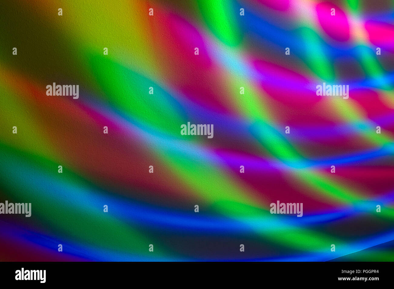 Disco lights with multicolored light streaks of repeating colors and ...