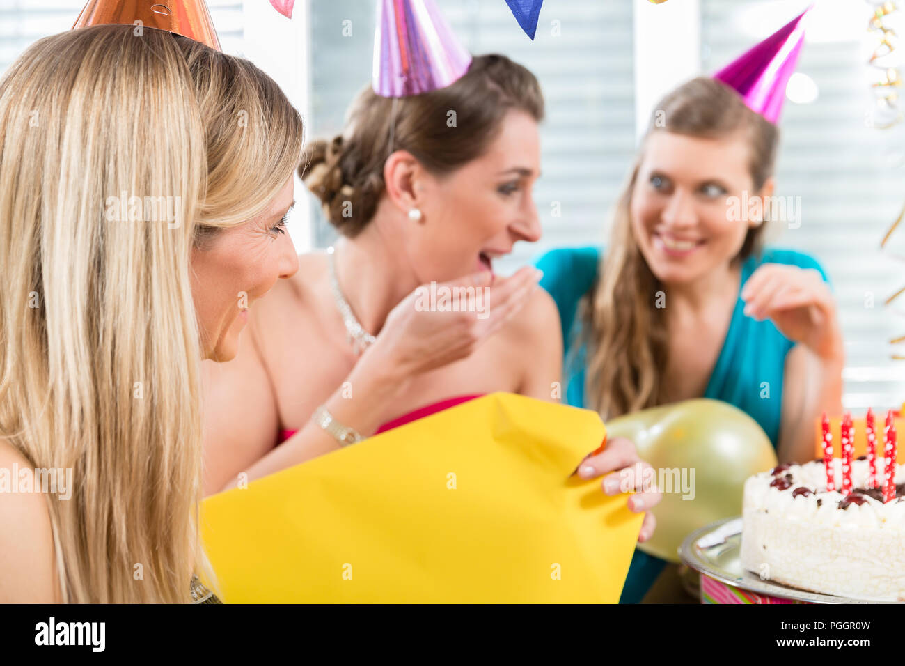 Beautiful woman opening a gift box while celebrating her birthday Stock ...