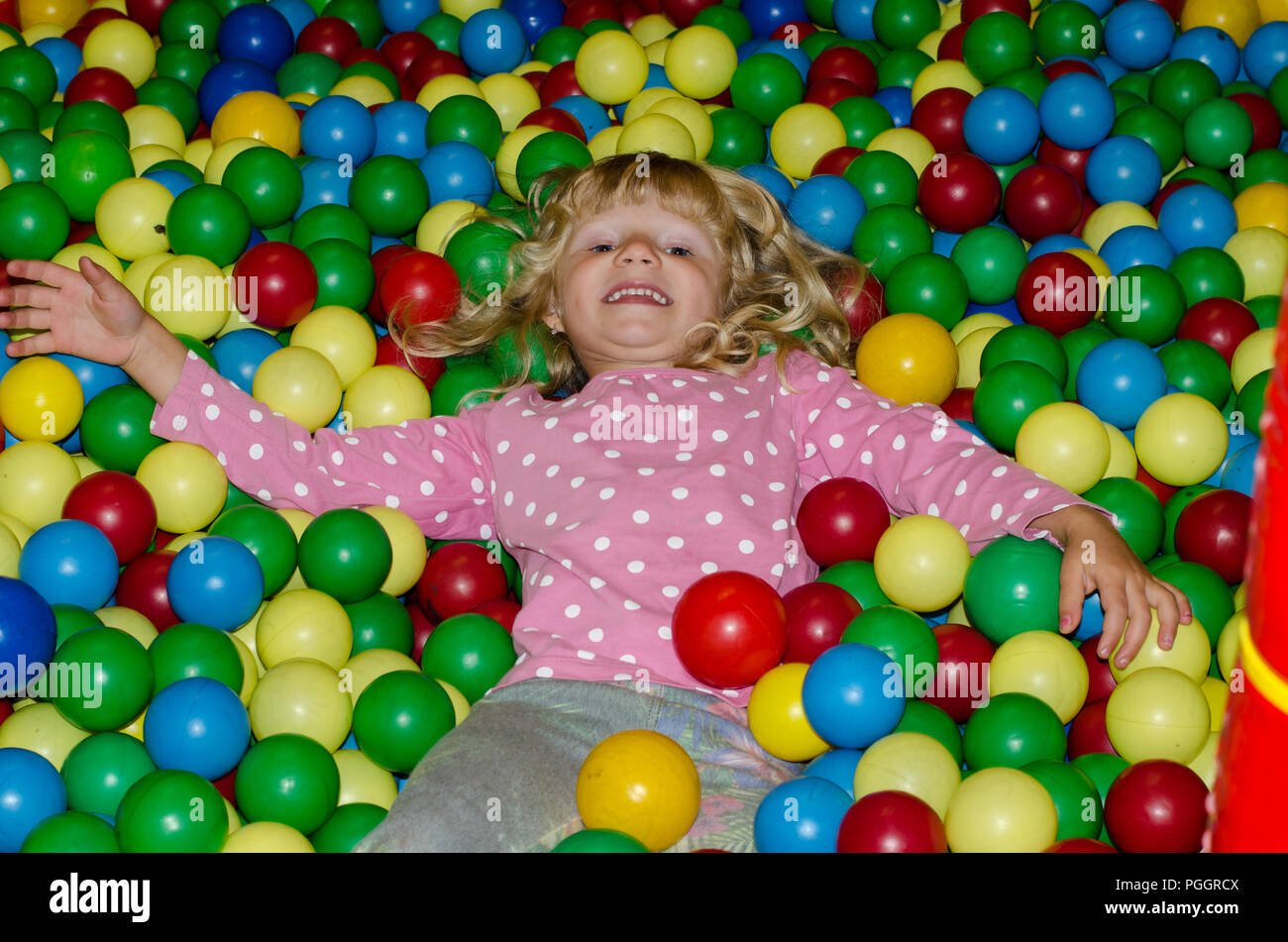 happy blond girl playing with colorful balls Stock Photo - Alamy