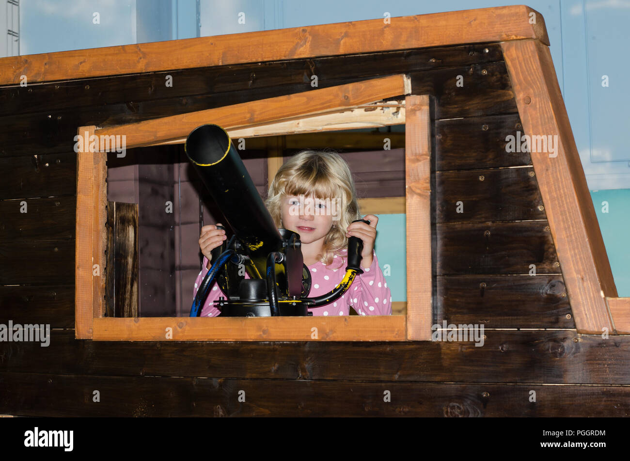 happy blond girl playing in atratuib oark Stock Photo - Alamy