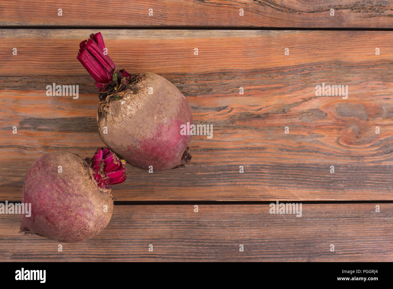Two beetroots on wood. Close up. Brown wooden background Stock Photo ...