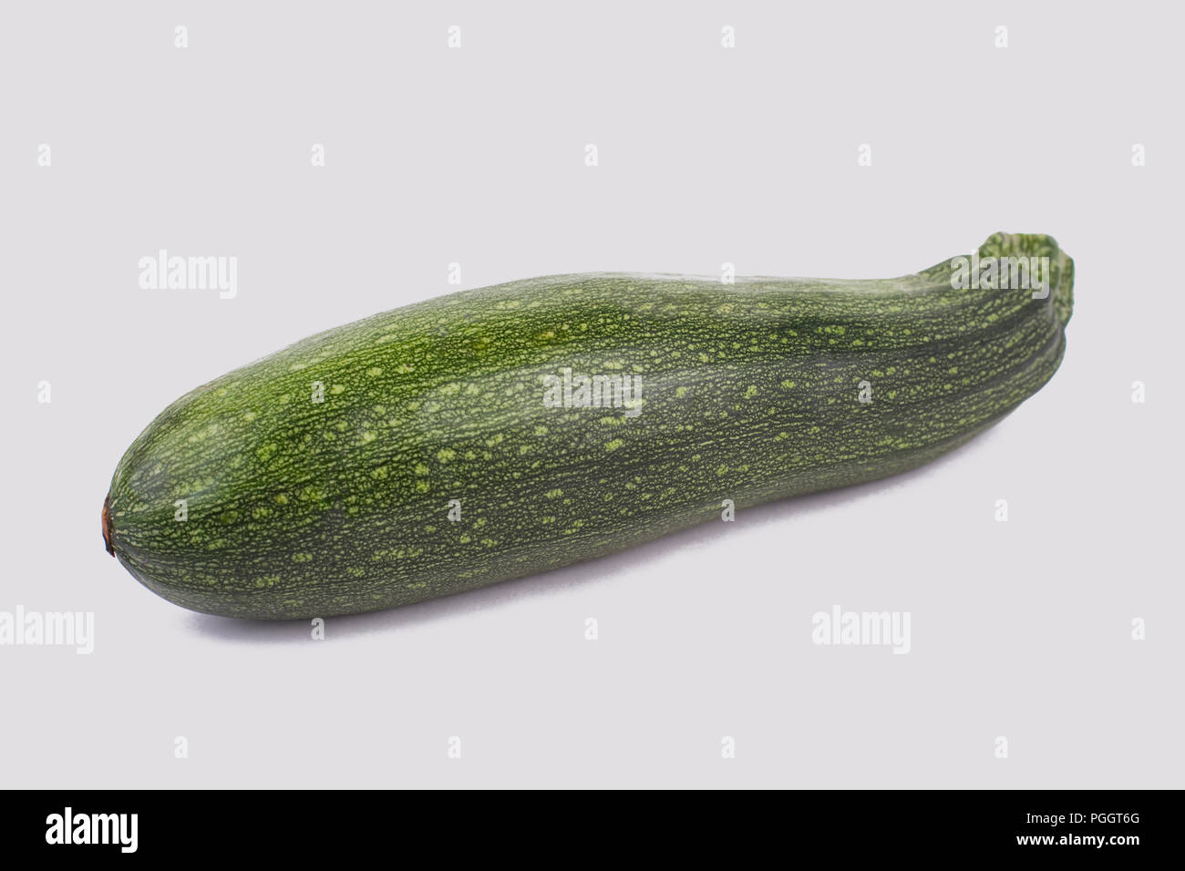 One single green courgette close up. White isolated background Stock ...