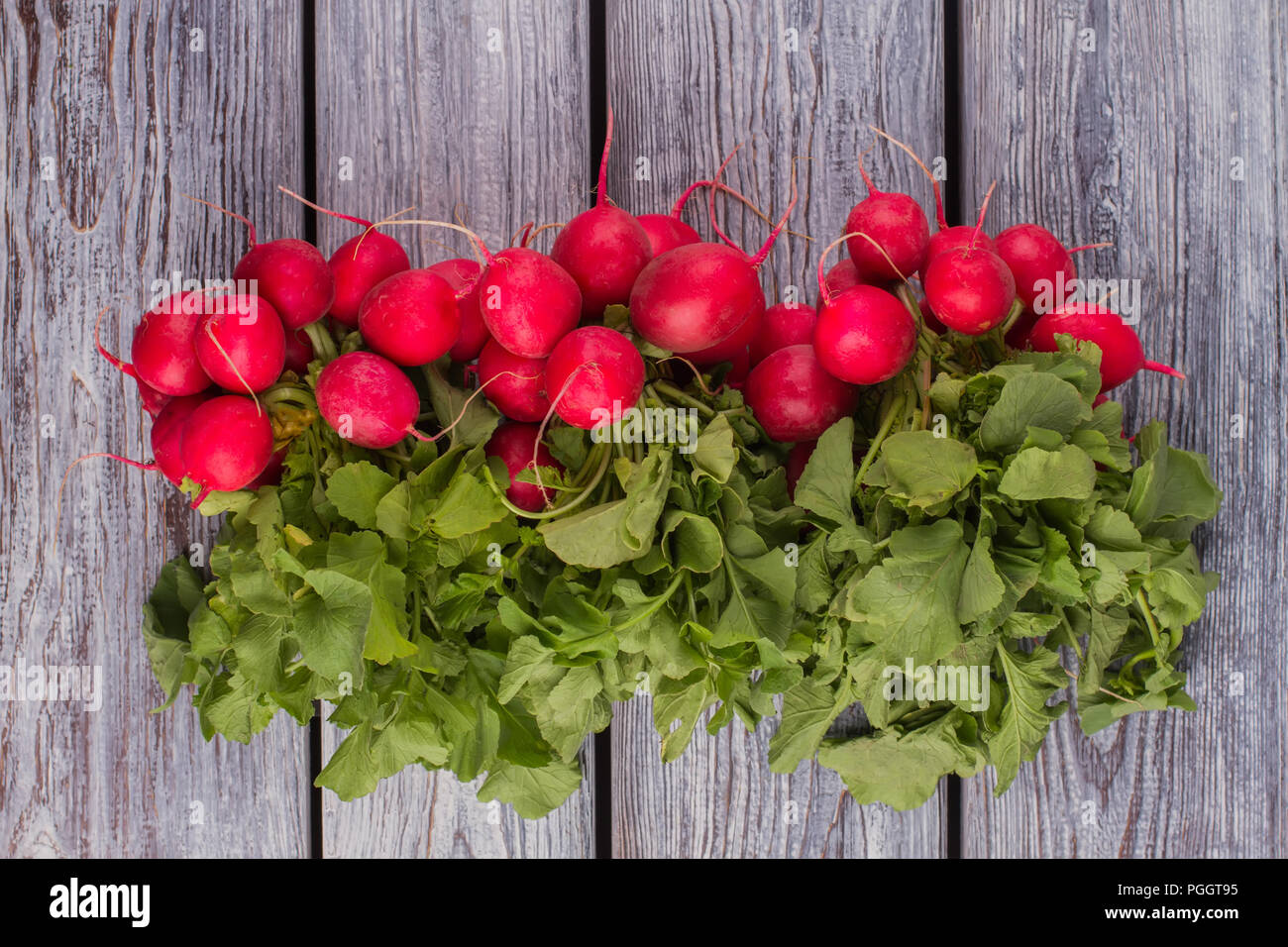 Tasty organic radish on wood, top view. Grey wooden background Stock ...