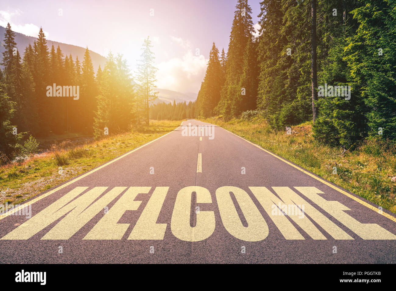 Welcome word written on road in the mountains Stock Photo - Alamy